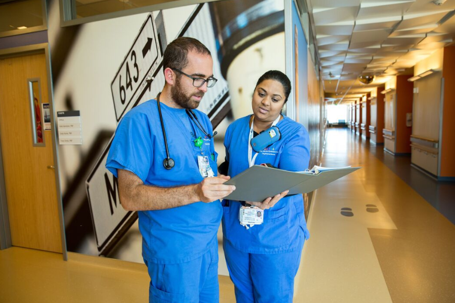 Health care professionals stand in a hospital hallway